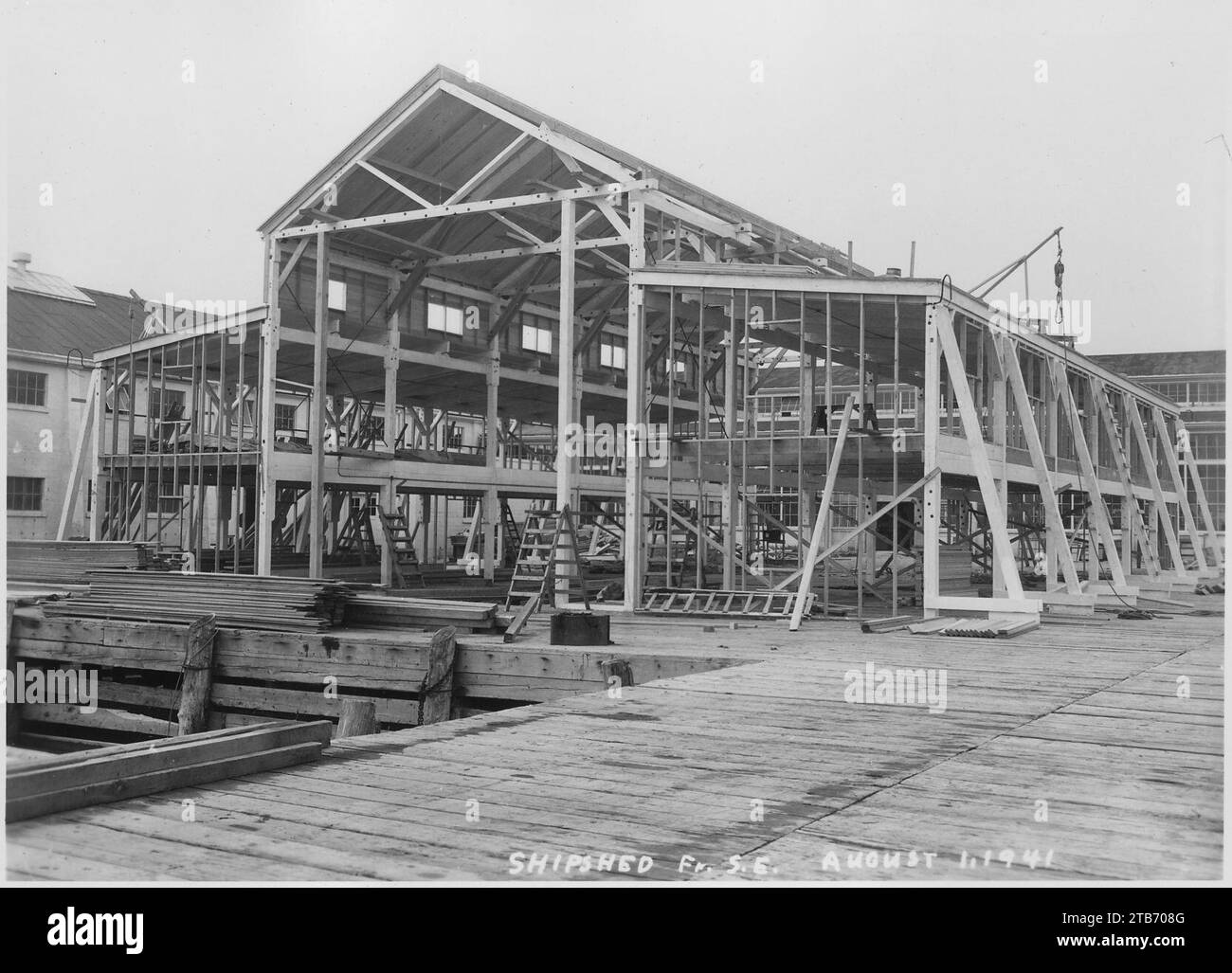 Wartime shipshed under construction. Note permanent shipshed building ...