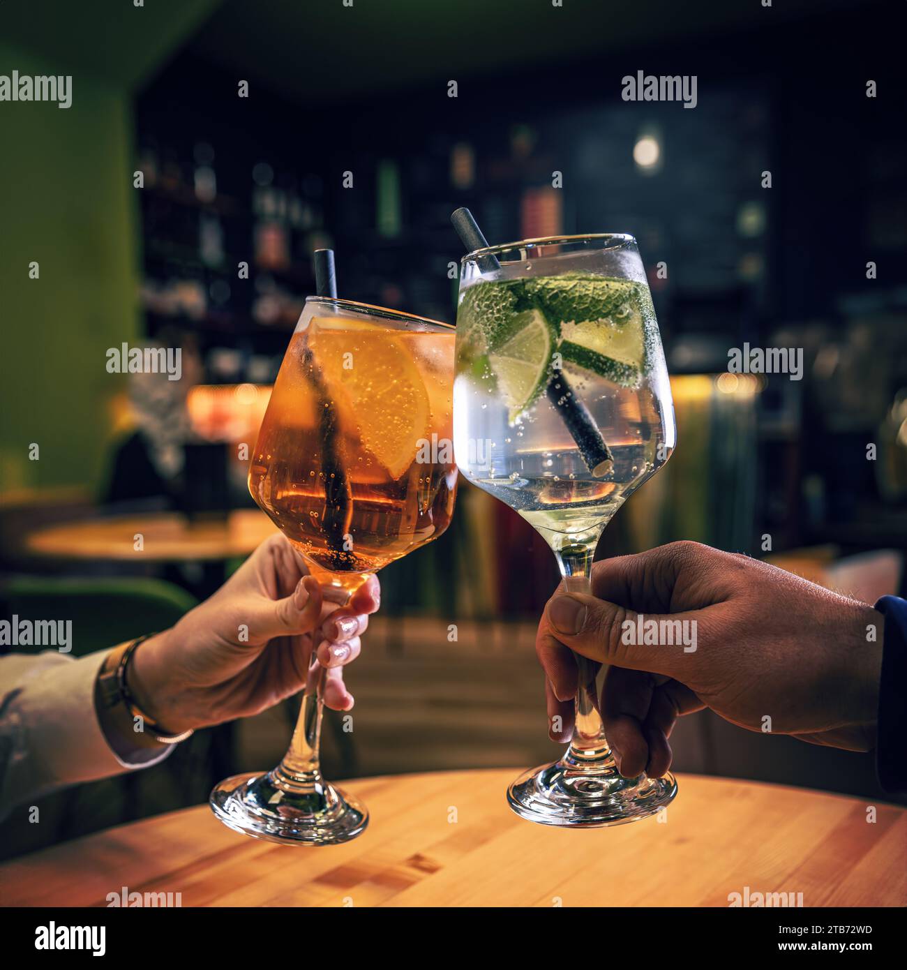 Toast with aperol spritz and gin tonic coctails Stock Photo - Alamy