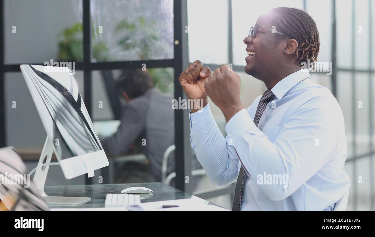 happy man working in the office. raised his hands joyfully Stock Photo ...