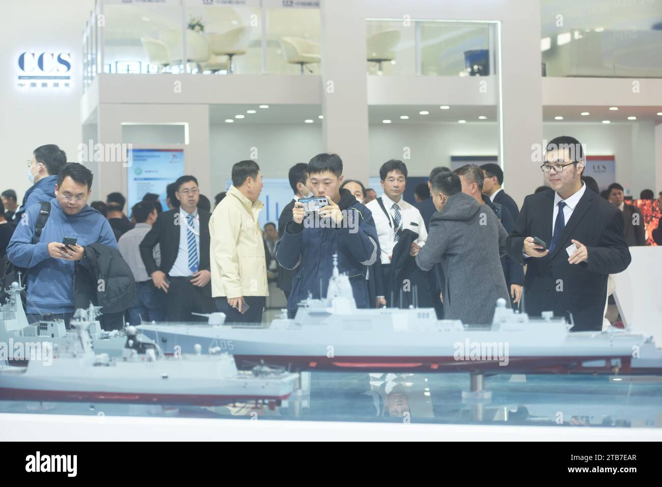 SHANGHAI, CHINA - DECEMBER 5, 2023 - Spectators look at a model of ...