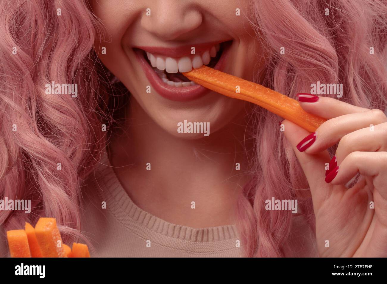 Attractive woman eating carrot hi-res stock photography and images - Alamy