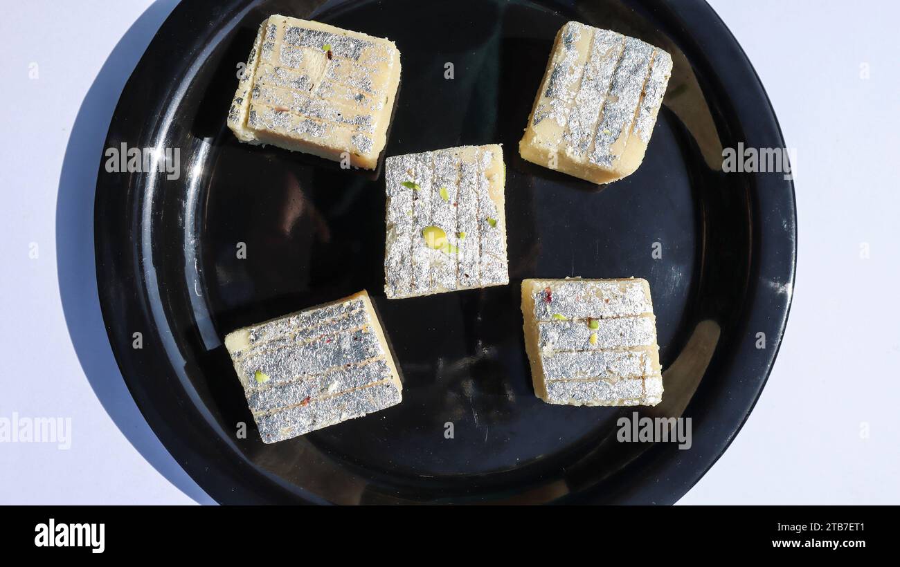 MIlk barfi or Milk khoya burfi. Indian sweets Barfee with silver foil ...