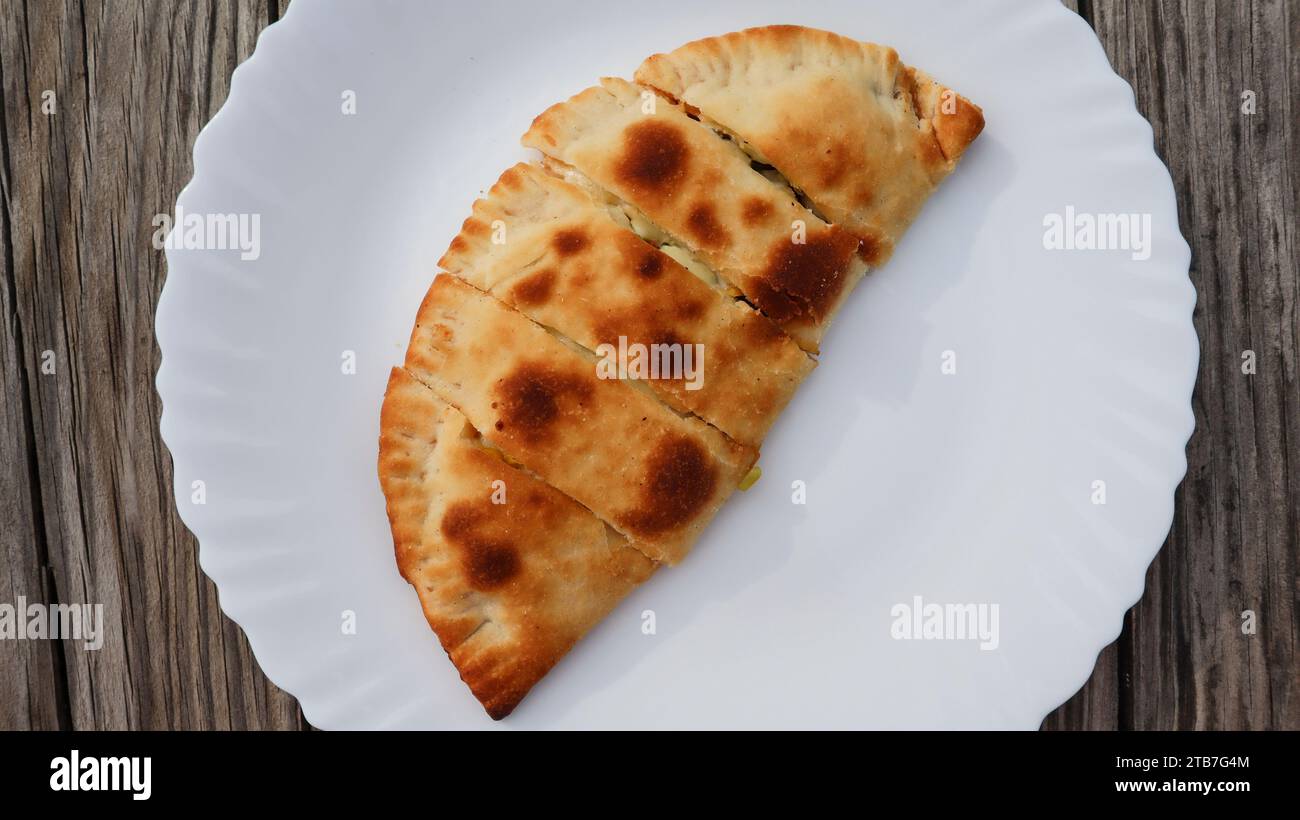 Italian dish Calzone in box, Veg calzone stuffed with cheese ...