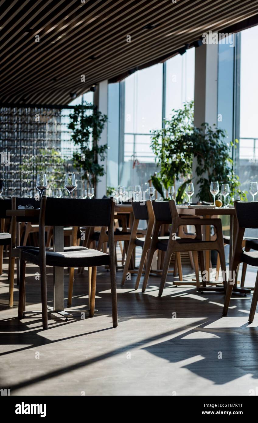 interior of a modern cafe with daylight. tables and chairs of a luxury ...