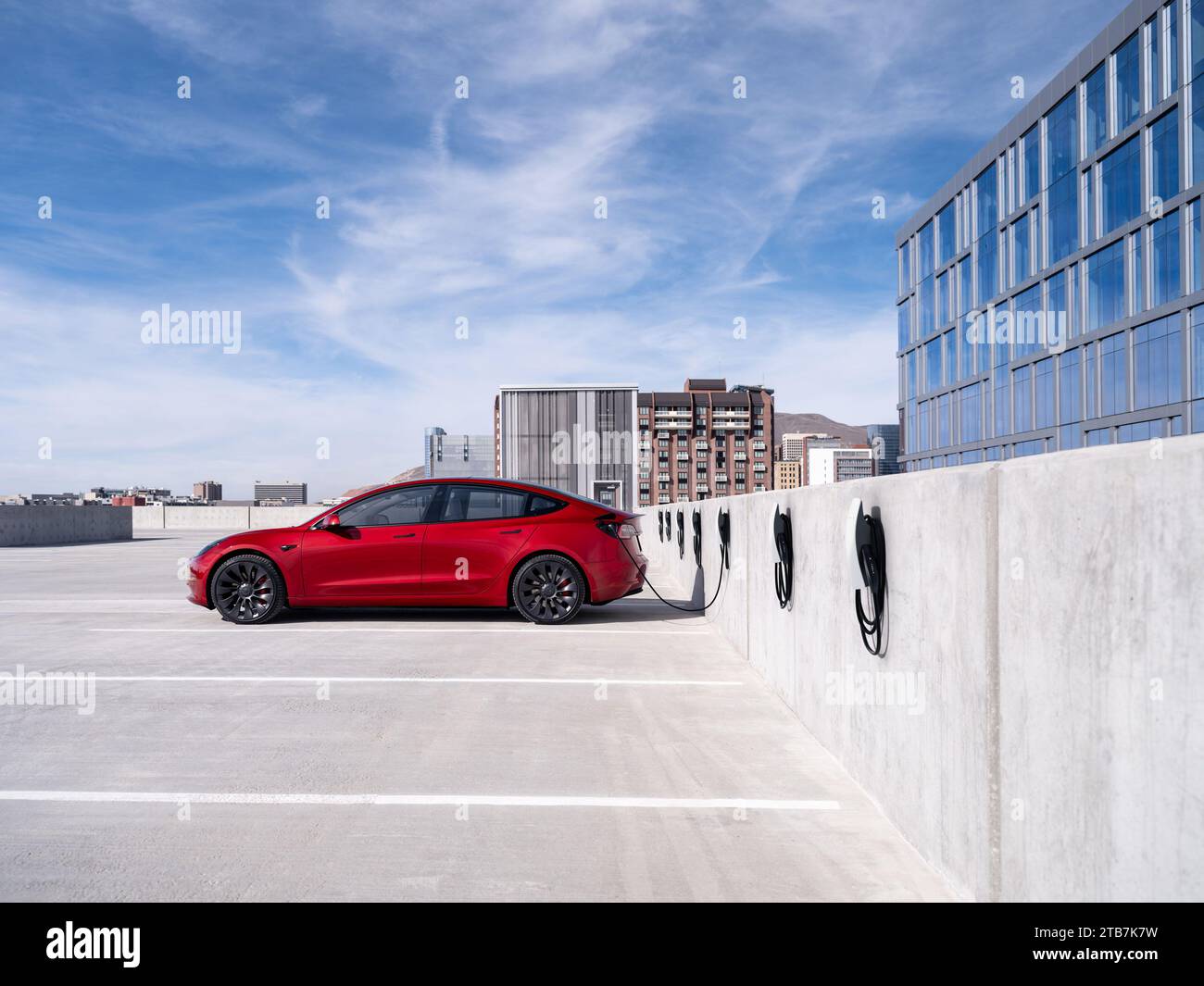 Charging a Tesla electric vehicle in the roof-top parking lot of an ...