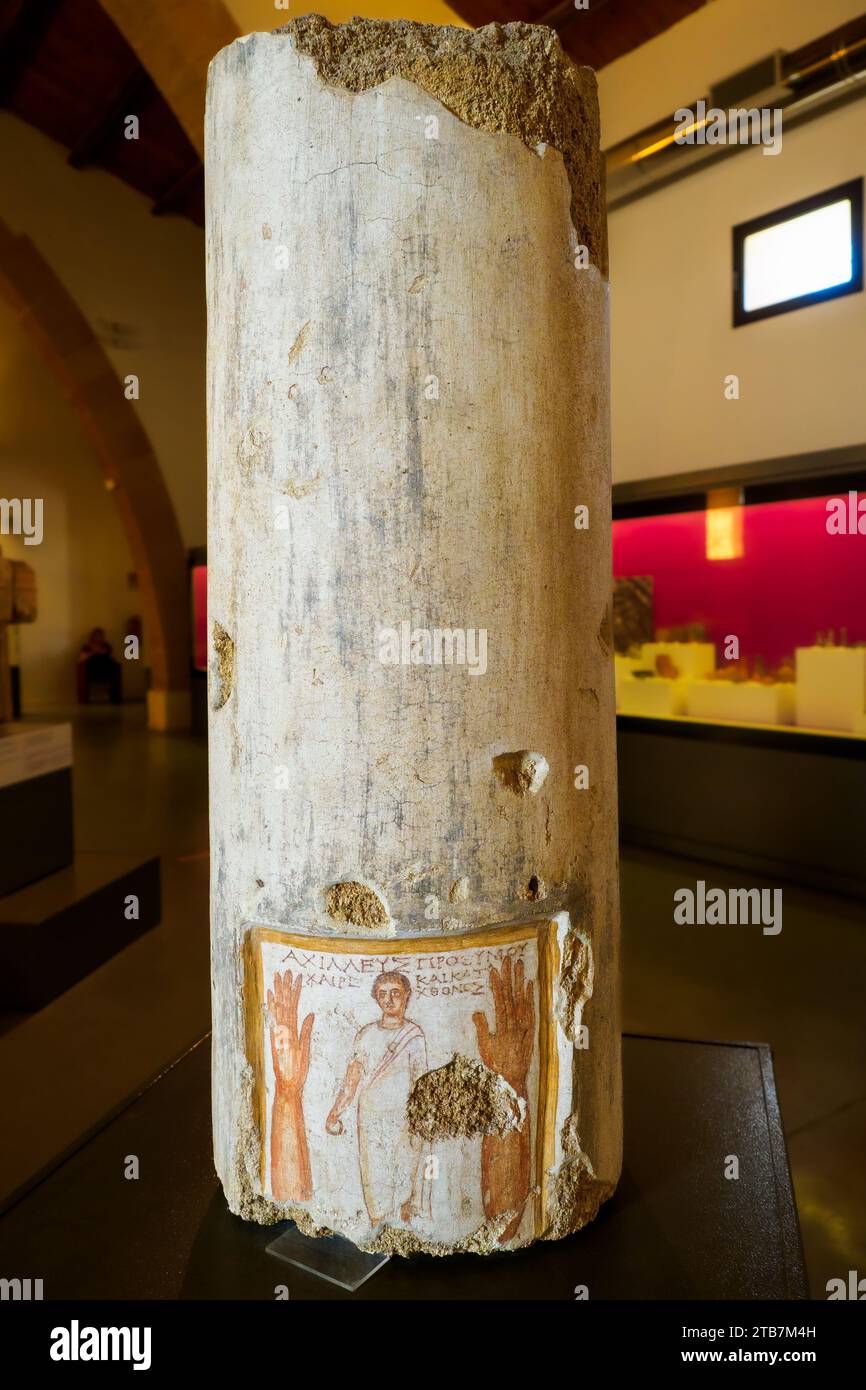 The young togaed deceased with a pomegranate in his right hand is ...