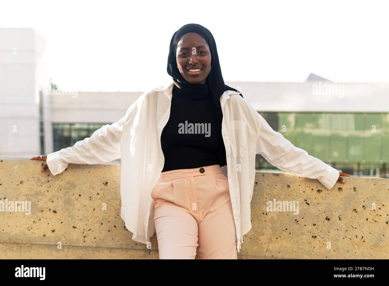 Portrait of happy calm Muslim young businesswoman in hijab and formals ...