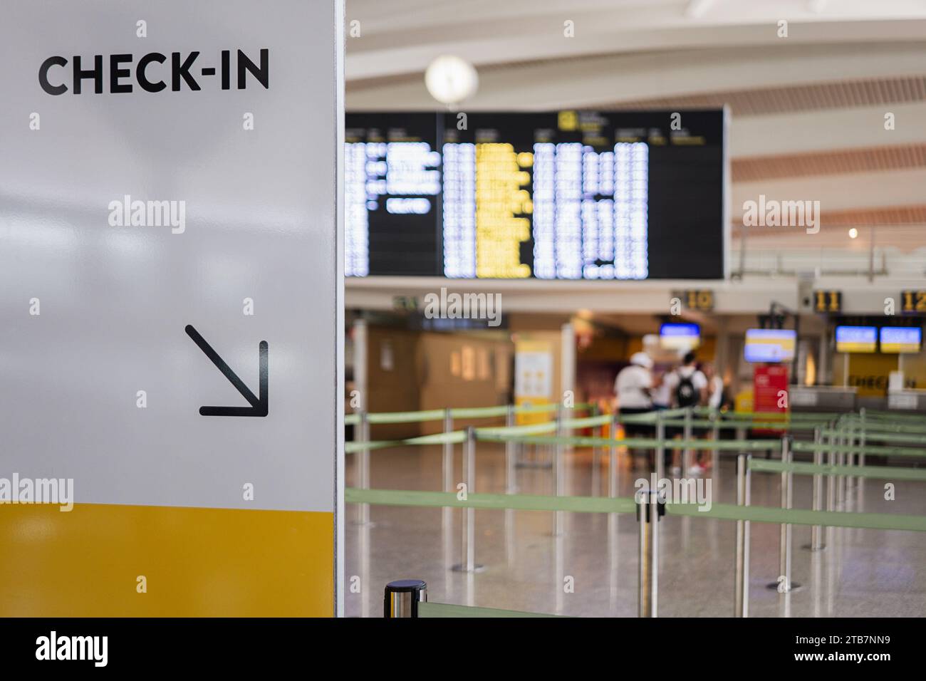 Check-in text with arrow symbol on placard board in lobby of airport ...