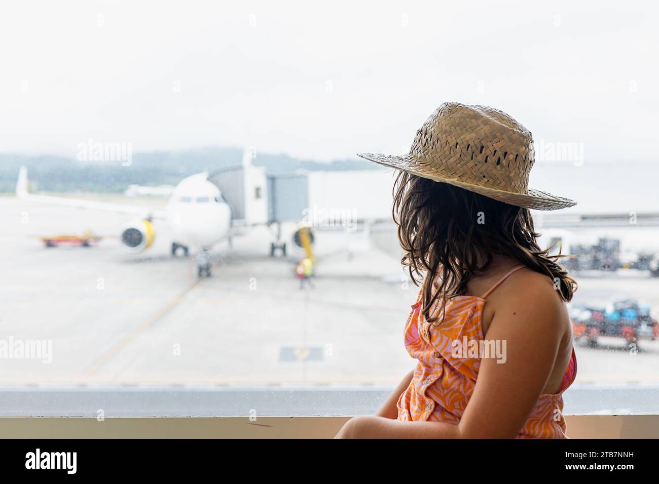 Side view of faceless girl traveler wearing straw hat and casuals ...
