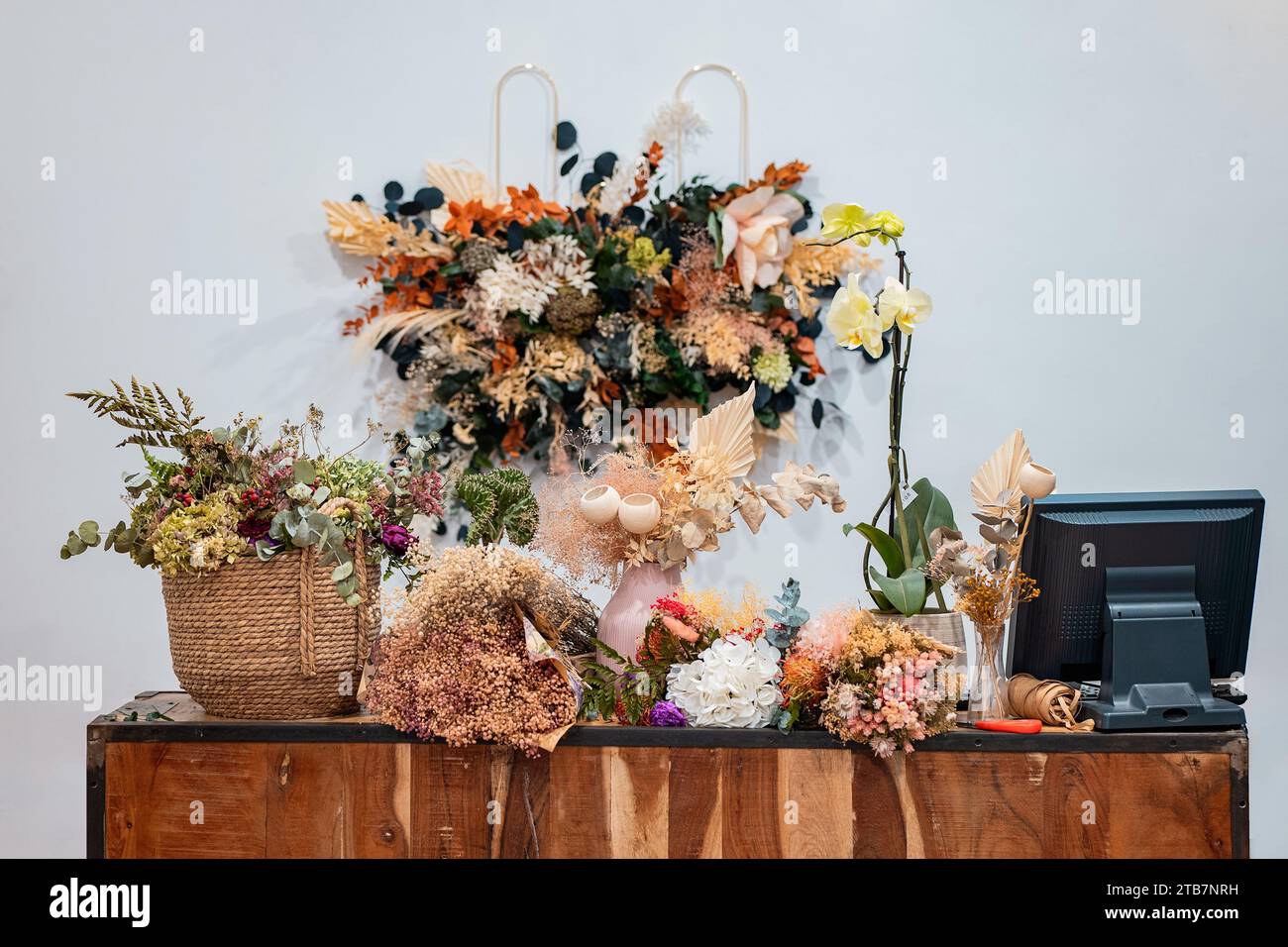 A diverse collection of dried floral arrangements adorning a wooden ...