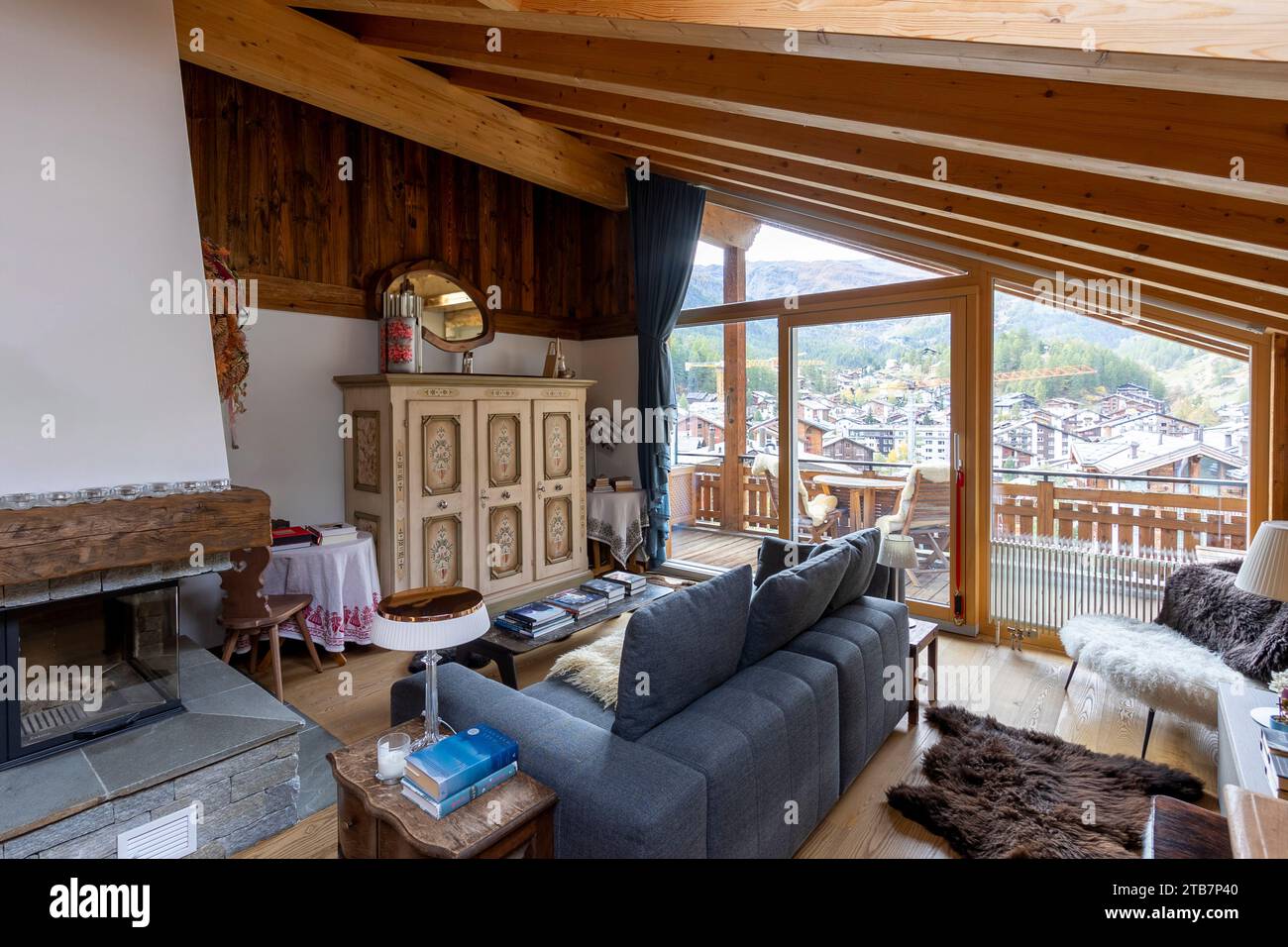A warm and inviting chalet living room featuring rustic wood beams ...