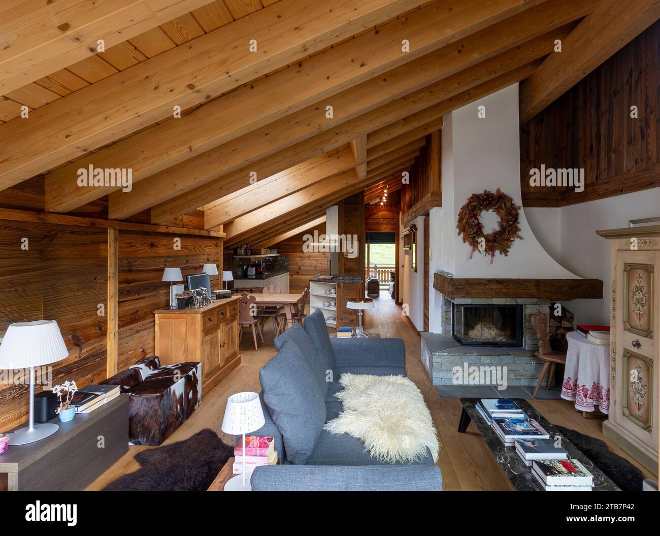 A warm and inviting chalet living room with exposed wooden beams, a ...