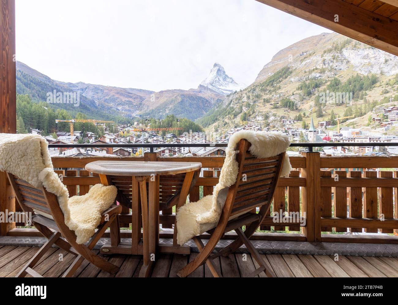 Cozy balcony setup with two chairs overlooking a scenic mountain ...
