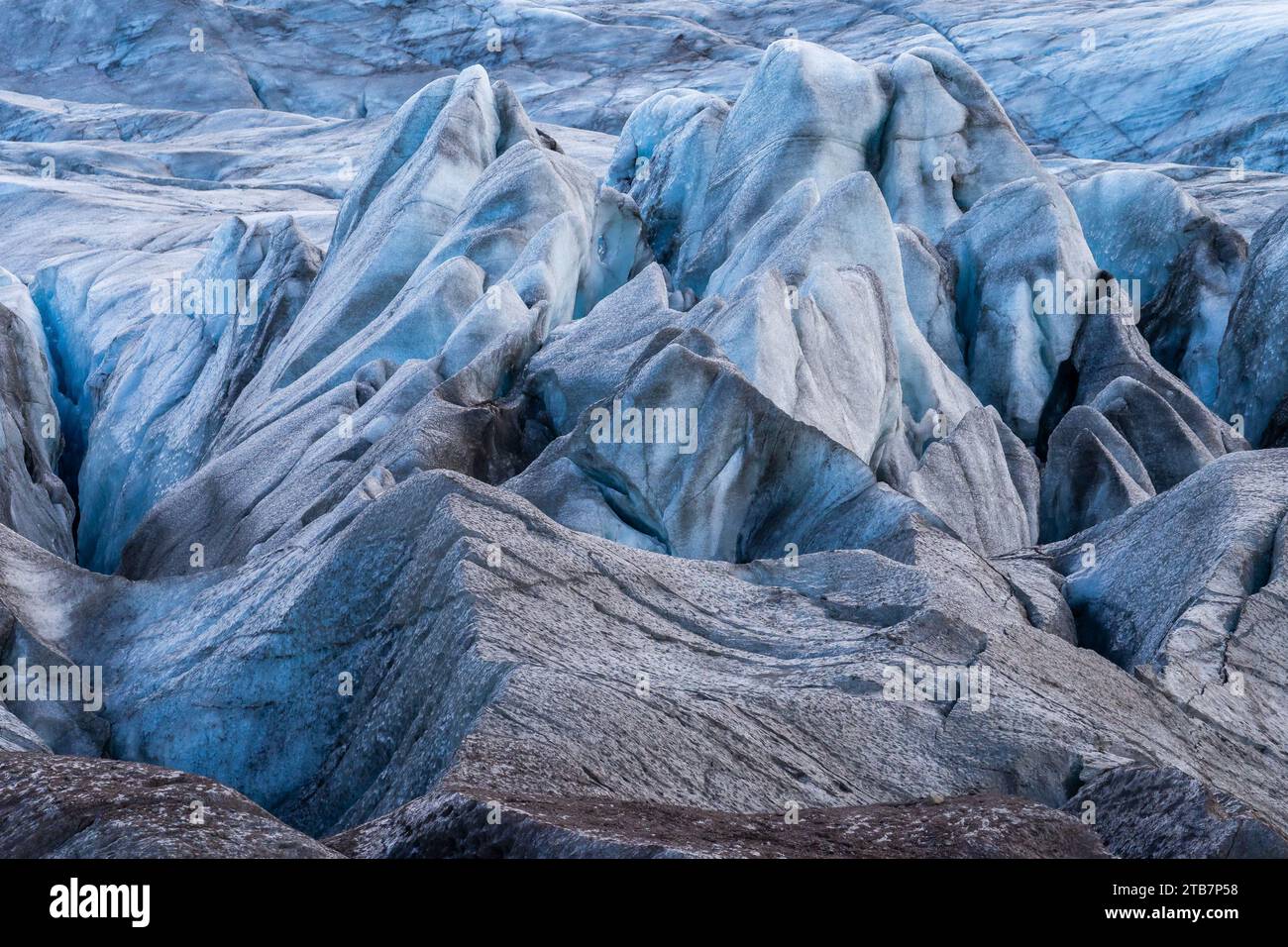A lone explorer stands amidst the immense icy landscape of Vatnajokull ...