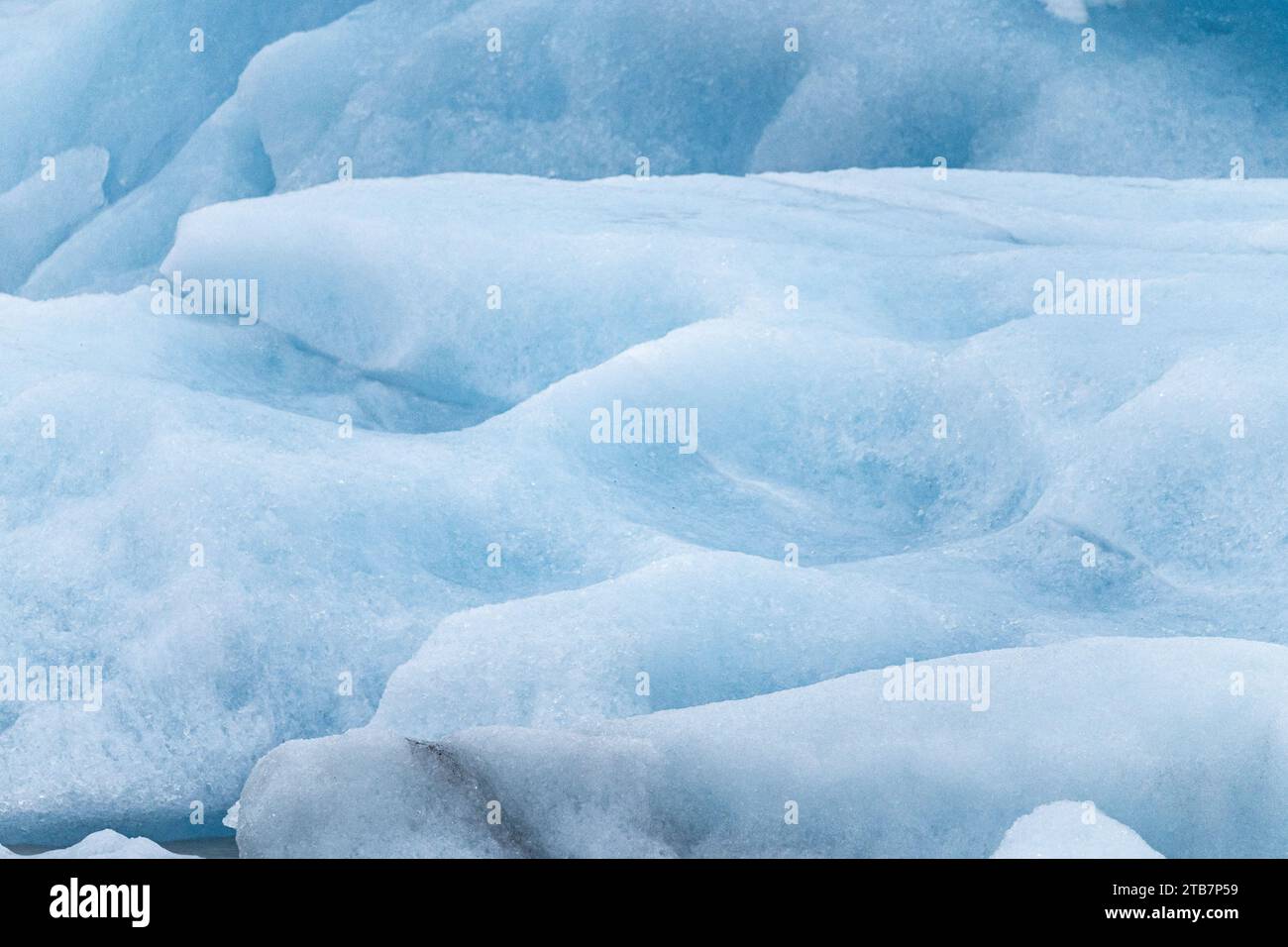 Striking blue ice formations stand amidst the chilly waters in the ...