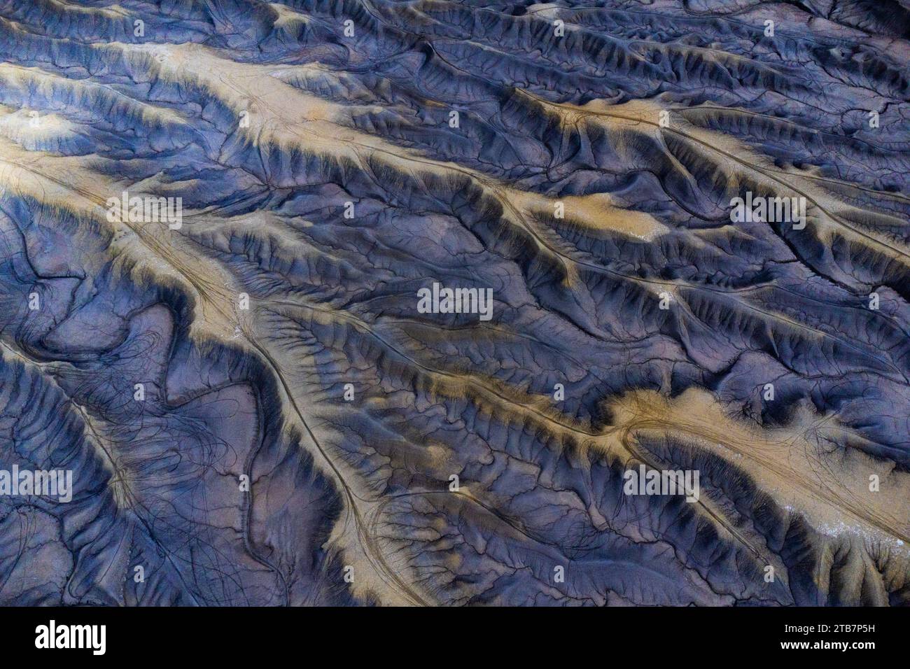 This image captures the intricate details of a winding rugged mountain ...