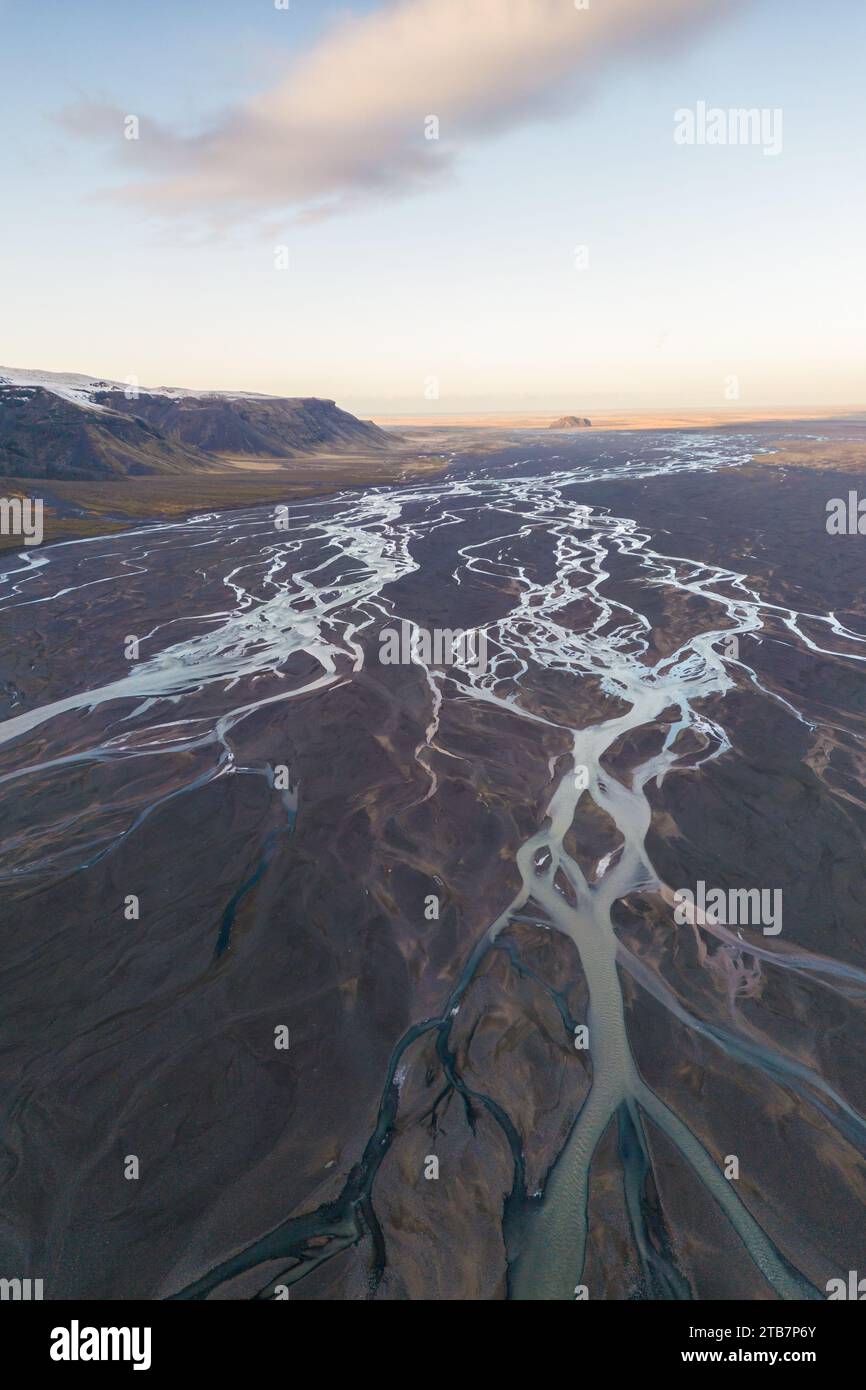 An aerial shot captures the intricate patterns of braided rivers ...