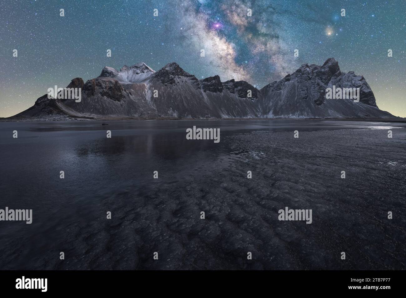 The galactic core of the Milky Way rises dramatically over a frozen ...