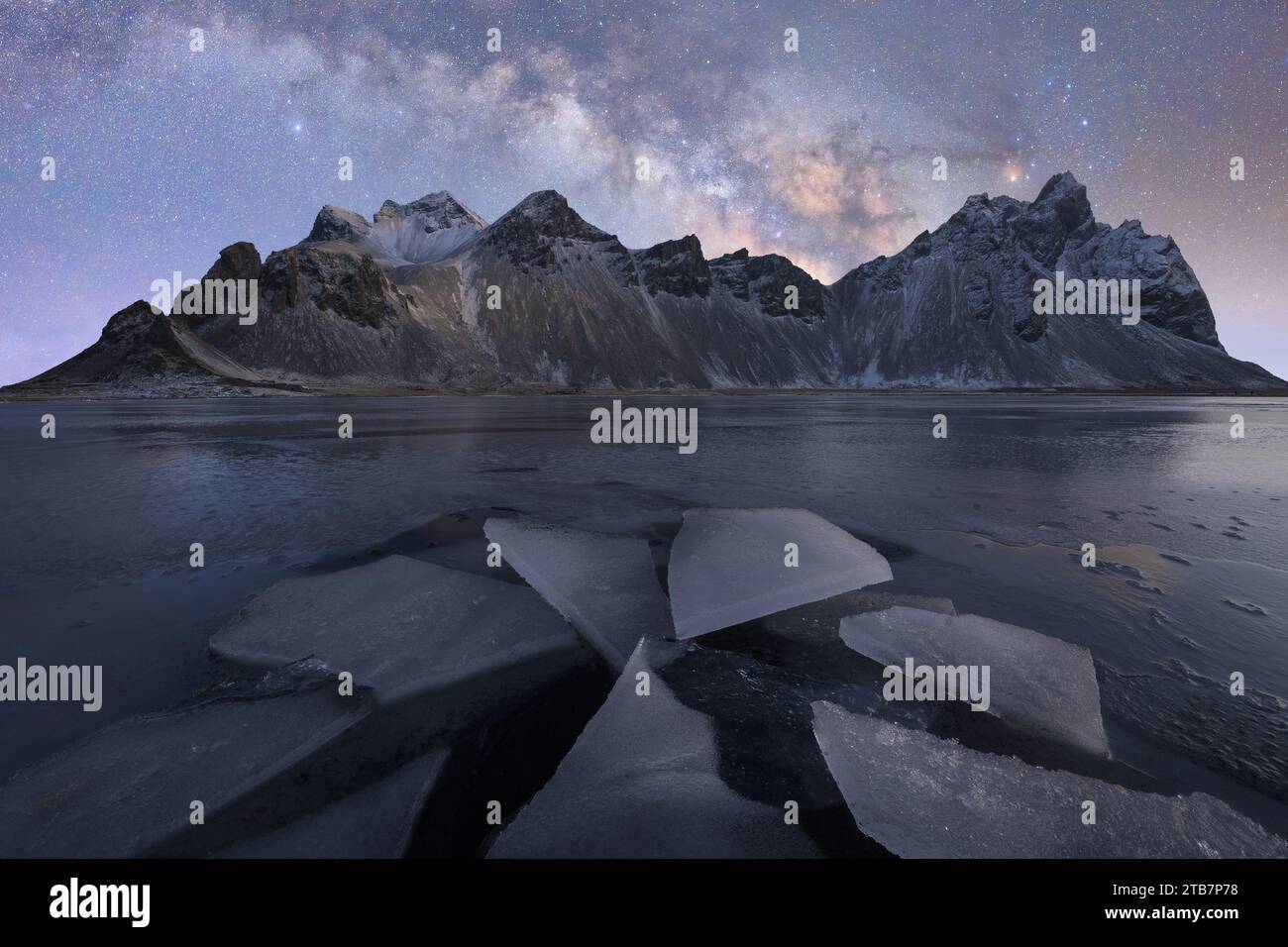 A serene night sky dusted with stars and the Milky Way gazes over an ...