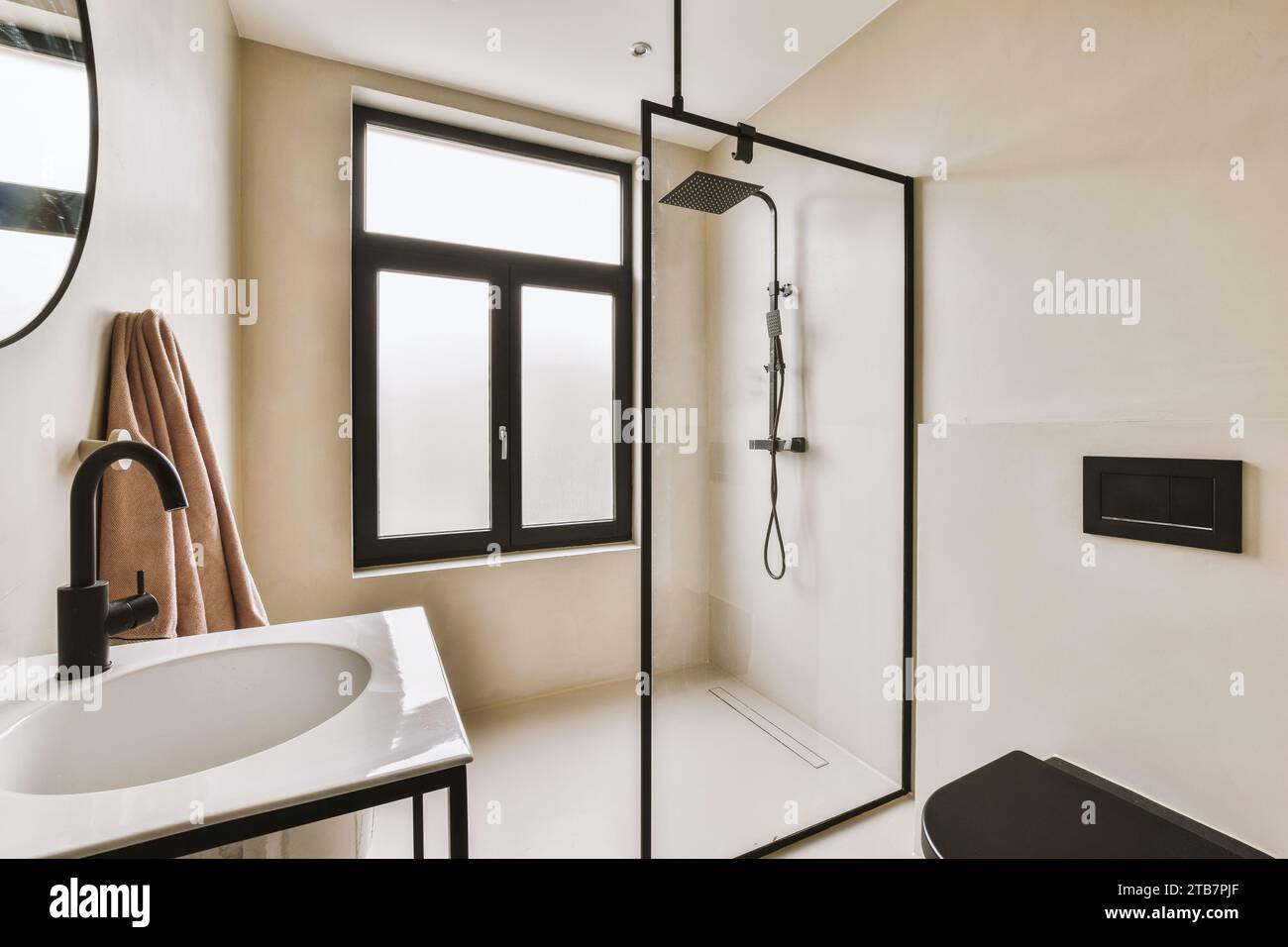 Interior of spacious white bathroom with shower booth and ceramic sink ...