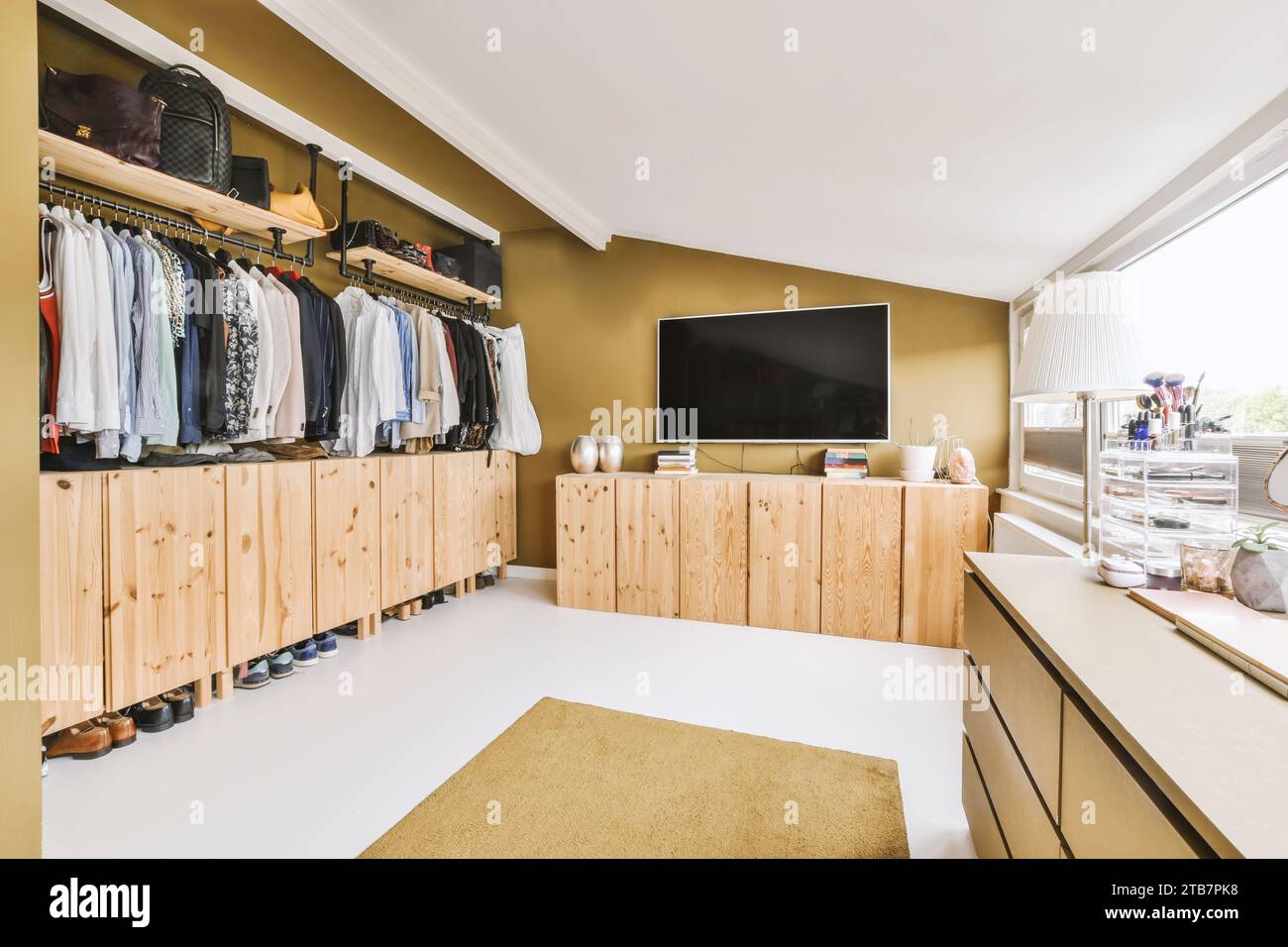 Interior of modern living room with open closet and television mounted ...