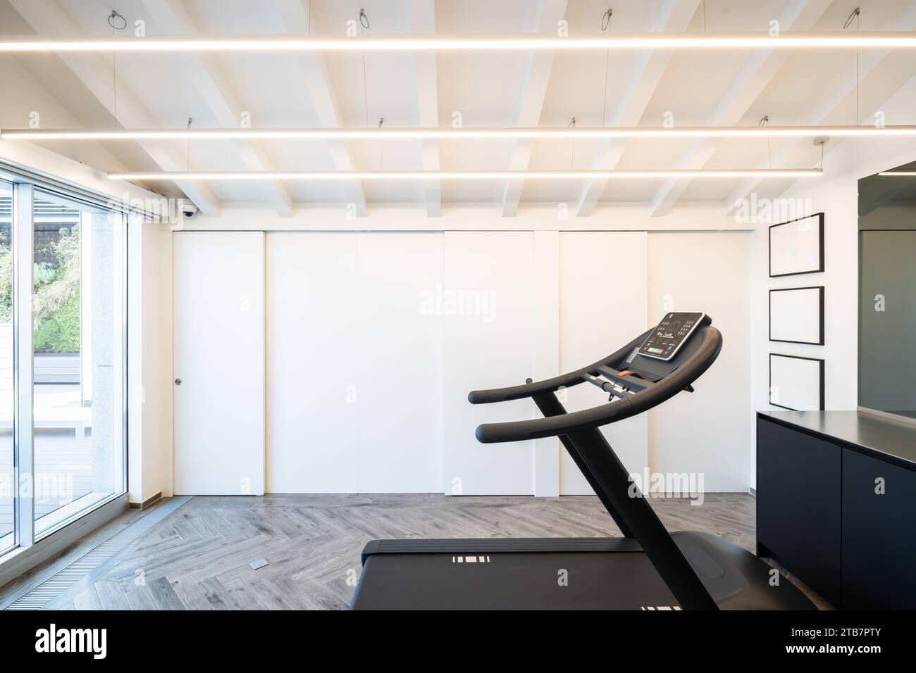 Treadmill on parquet floor in modern exercise room of luxurious ...