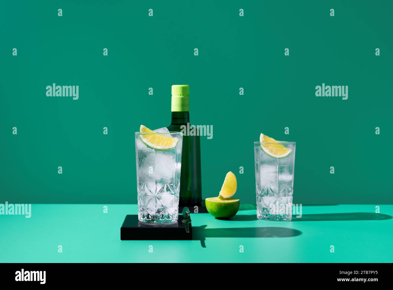 An elegant display of gin tonic in two glasses with ice and lime ...
