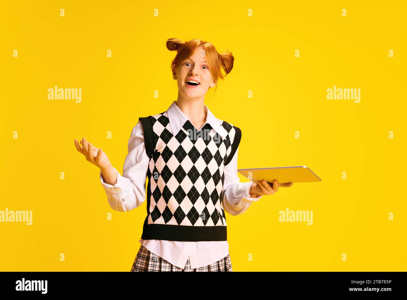 Portrait of adorable, pleasantly surprised girl, student holding tablet ...