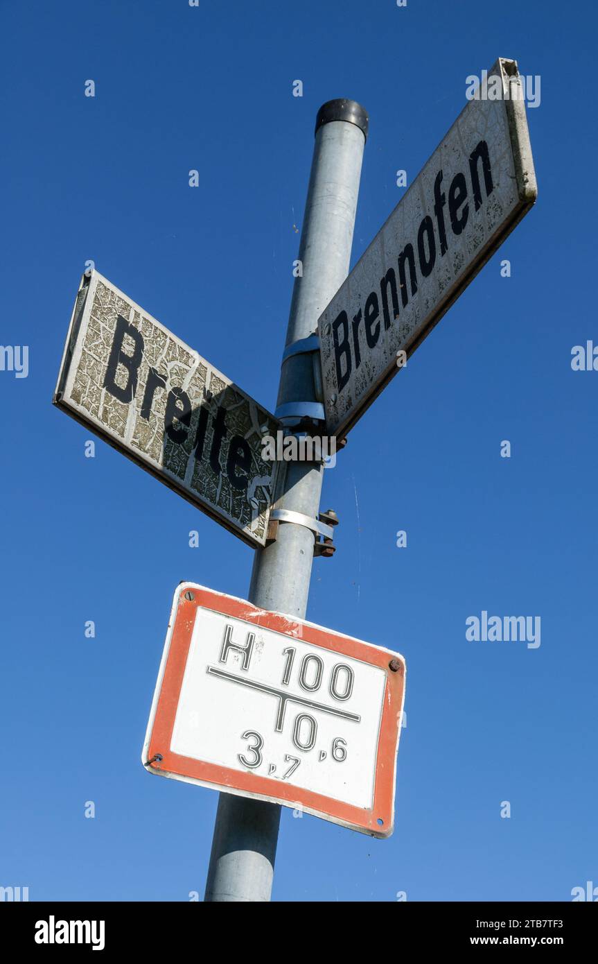 The two road signs and a fire hydrant sign on a pole Stock Photo - Alamy