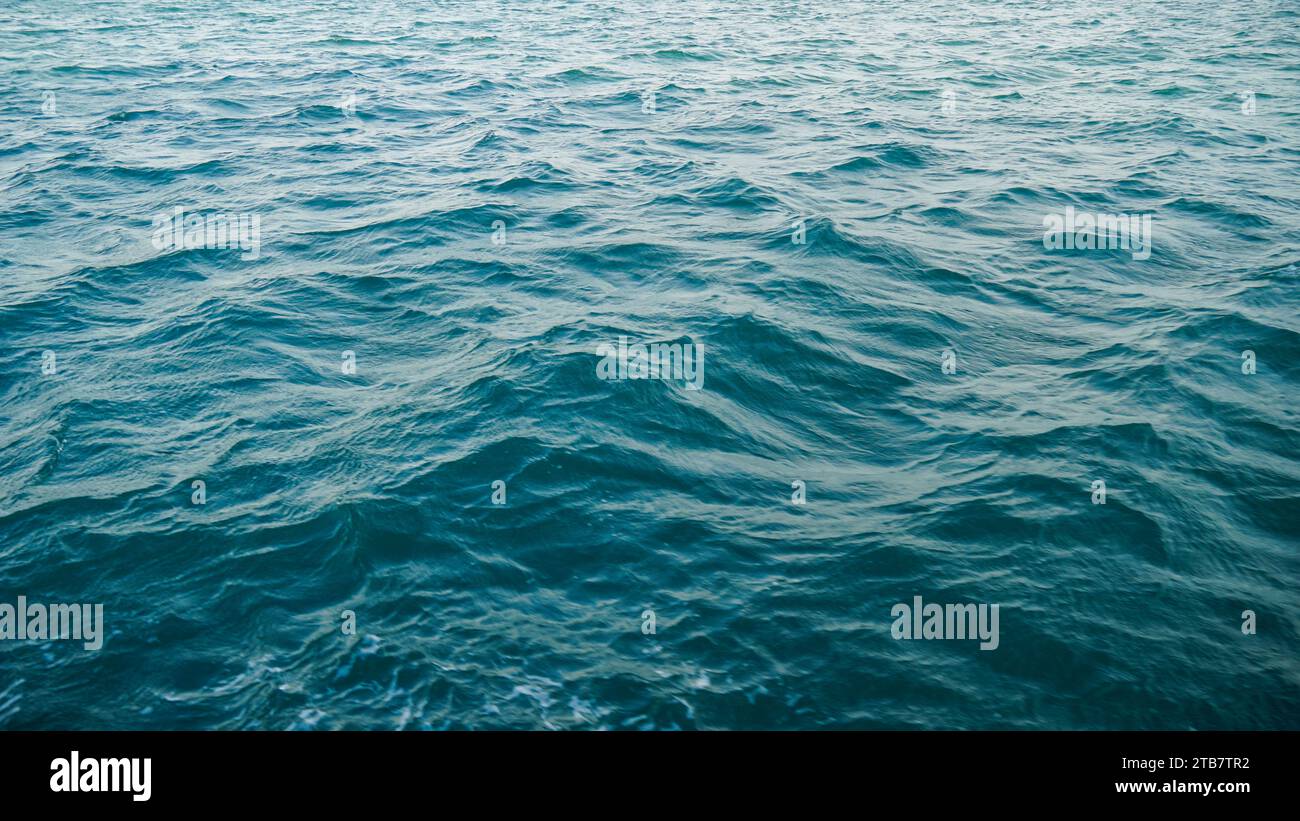 An abstract background of seawater flow under light exposure. sea wave ...