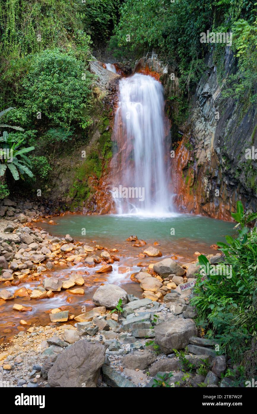 The Red Rocks waterfall cascading over a rugged landscape of rocks in ...