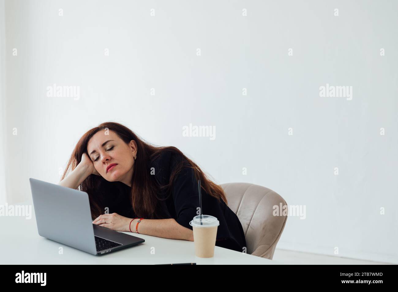 Tired business woman sleeping at desk at work in front of laptop Stock ...