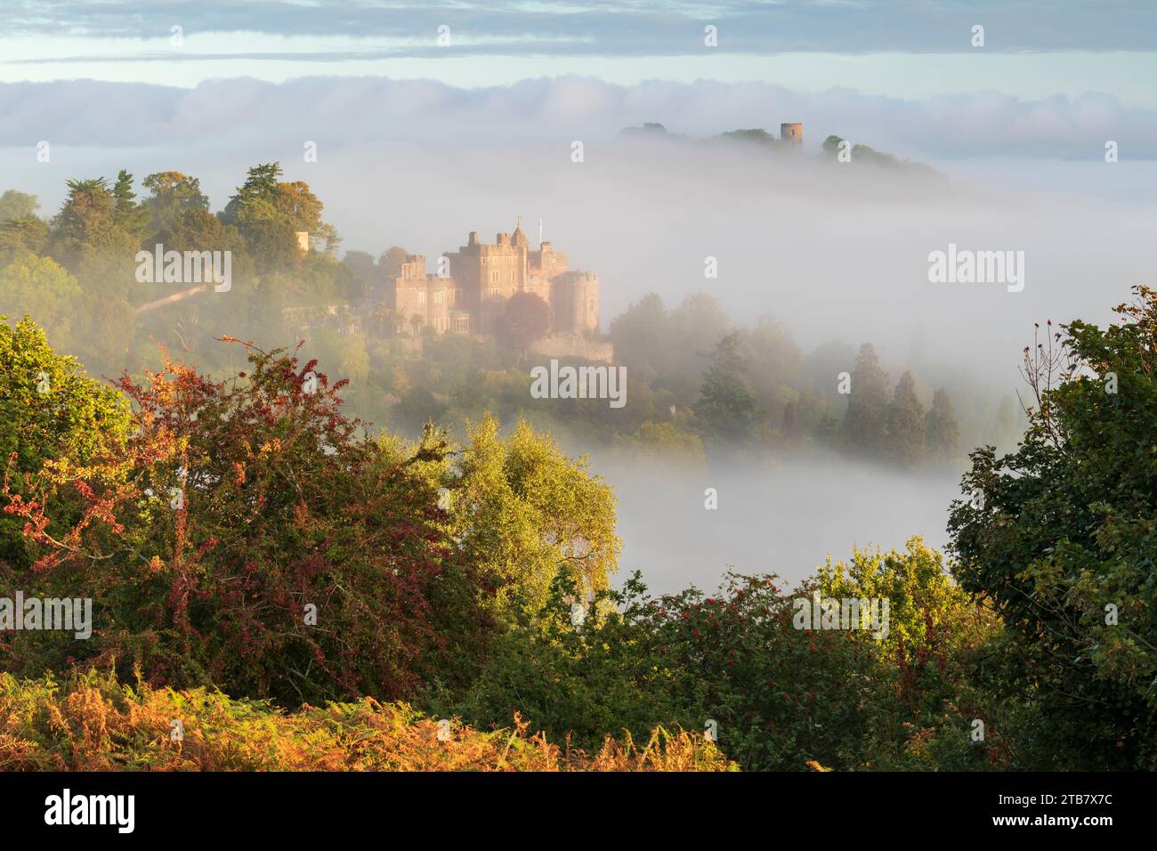 Beautiful autumnal misty morning overlooking Dunster Castle and Conygar ...