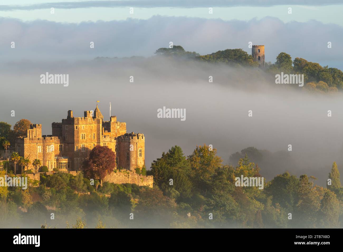 Dunster Castle and Conygar Tower emerging from morning mist, Dunster ...