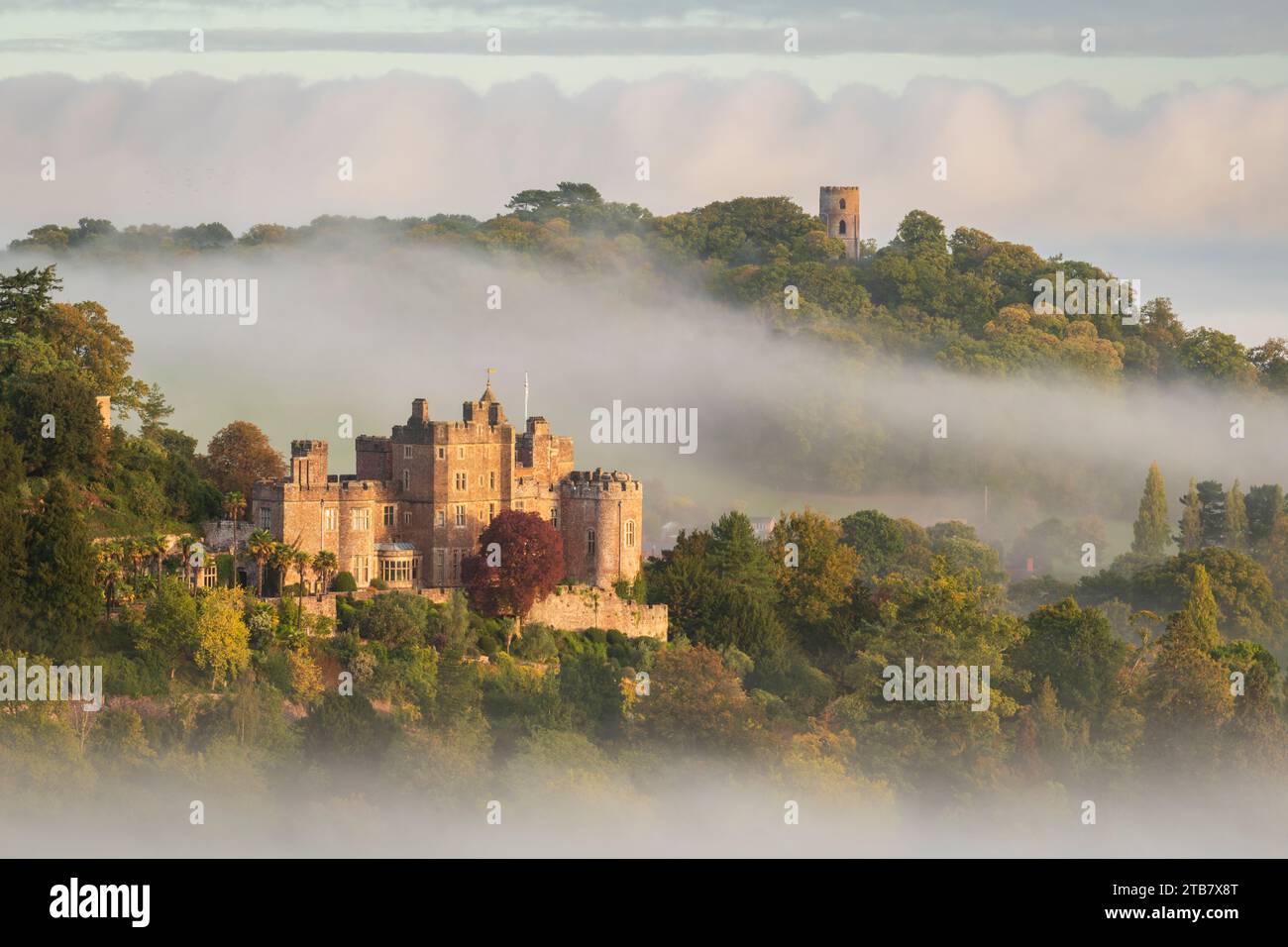 Dunster Castle and Conygar Tower emerging from morning mist, Dunster ...