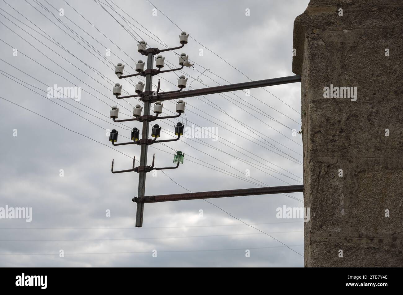 Detail of the support of the electrical network pole anchored to the ...