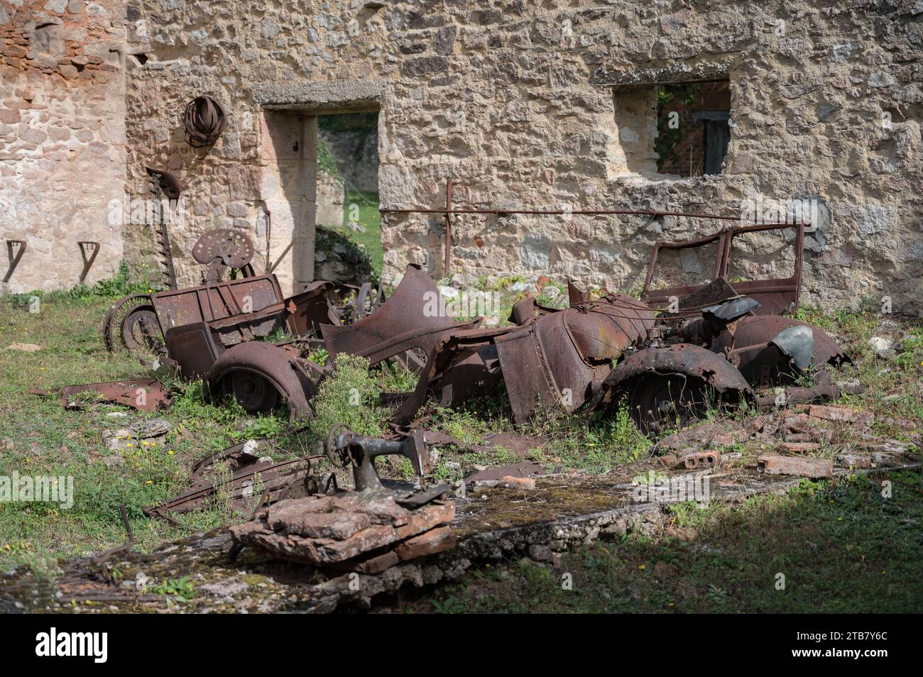 Scrap metal remains of a car and a tractor from a farmer's house that ...