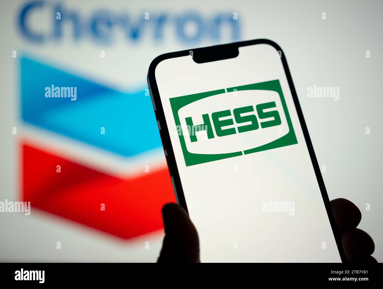 The Hess logo is seen with the Chevron logo in the background in this ...