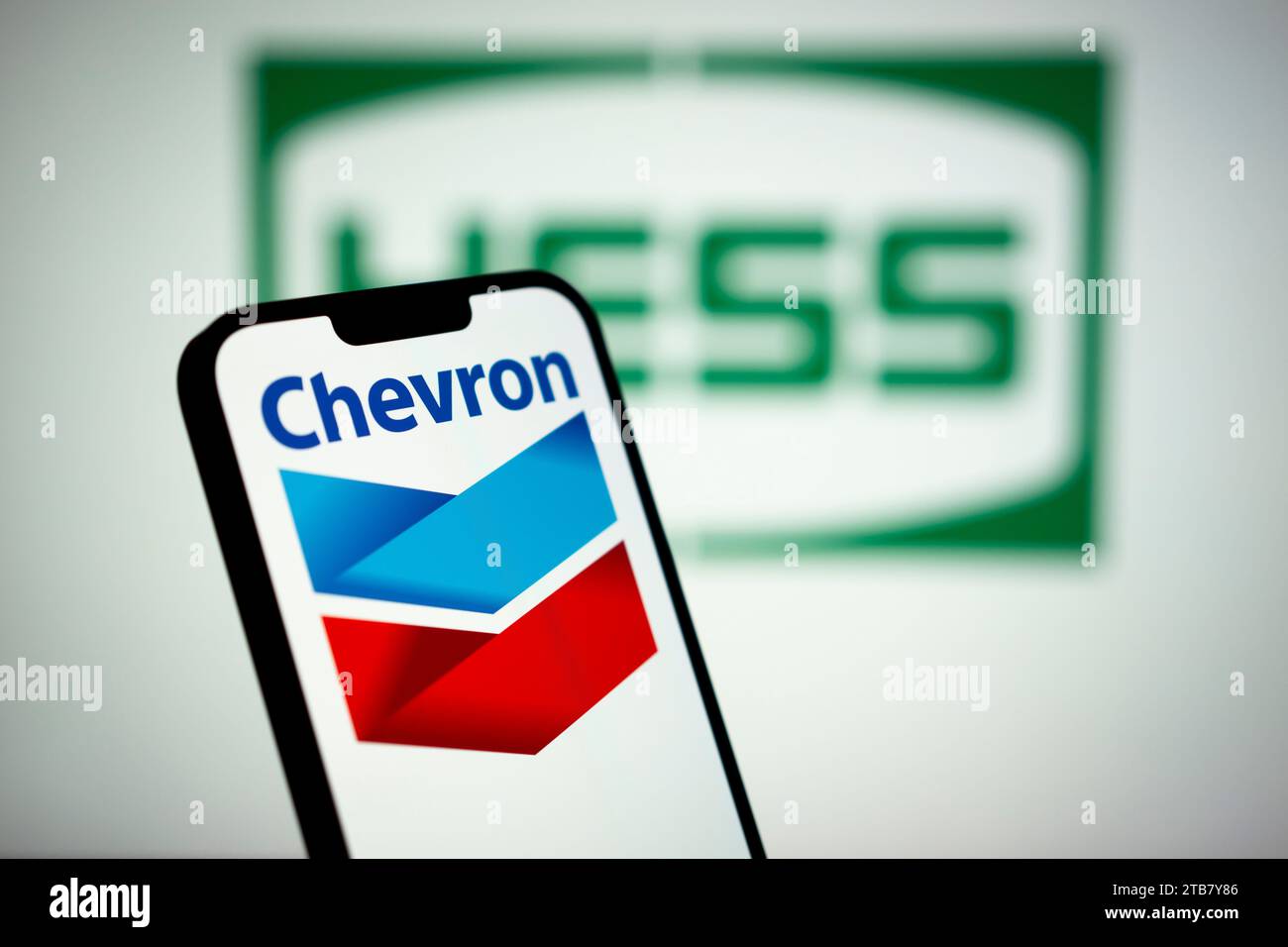 The Chevron logo is seen with the Hess logo in the background in this ...