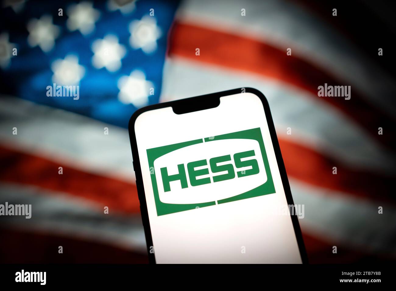 The Hess logo is seen with an American flag in the background in this ...
