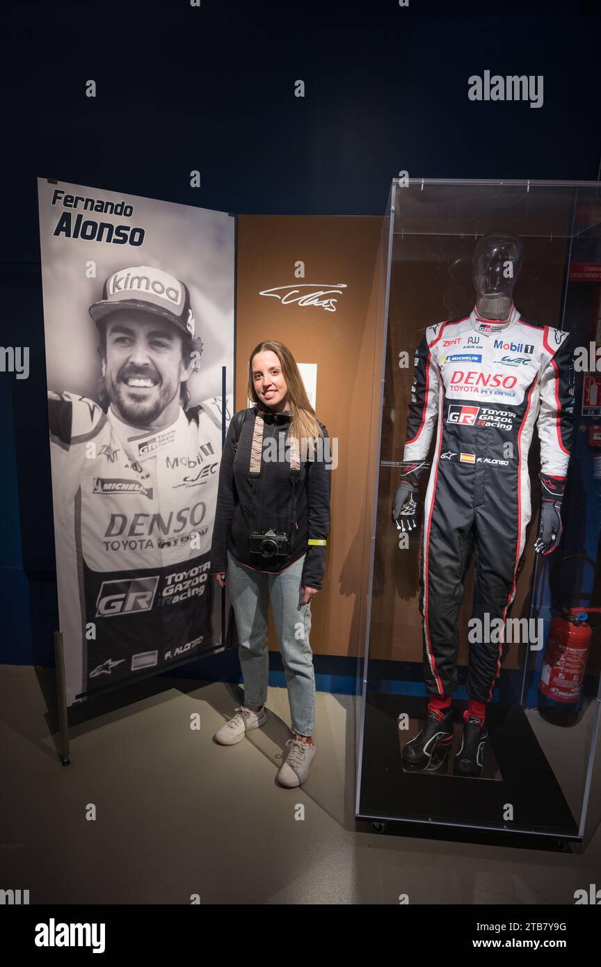 A young girl who is a fan of Fernando Alonso takes a photo with his ...