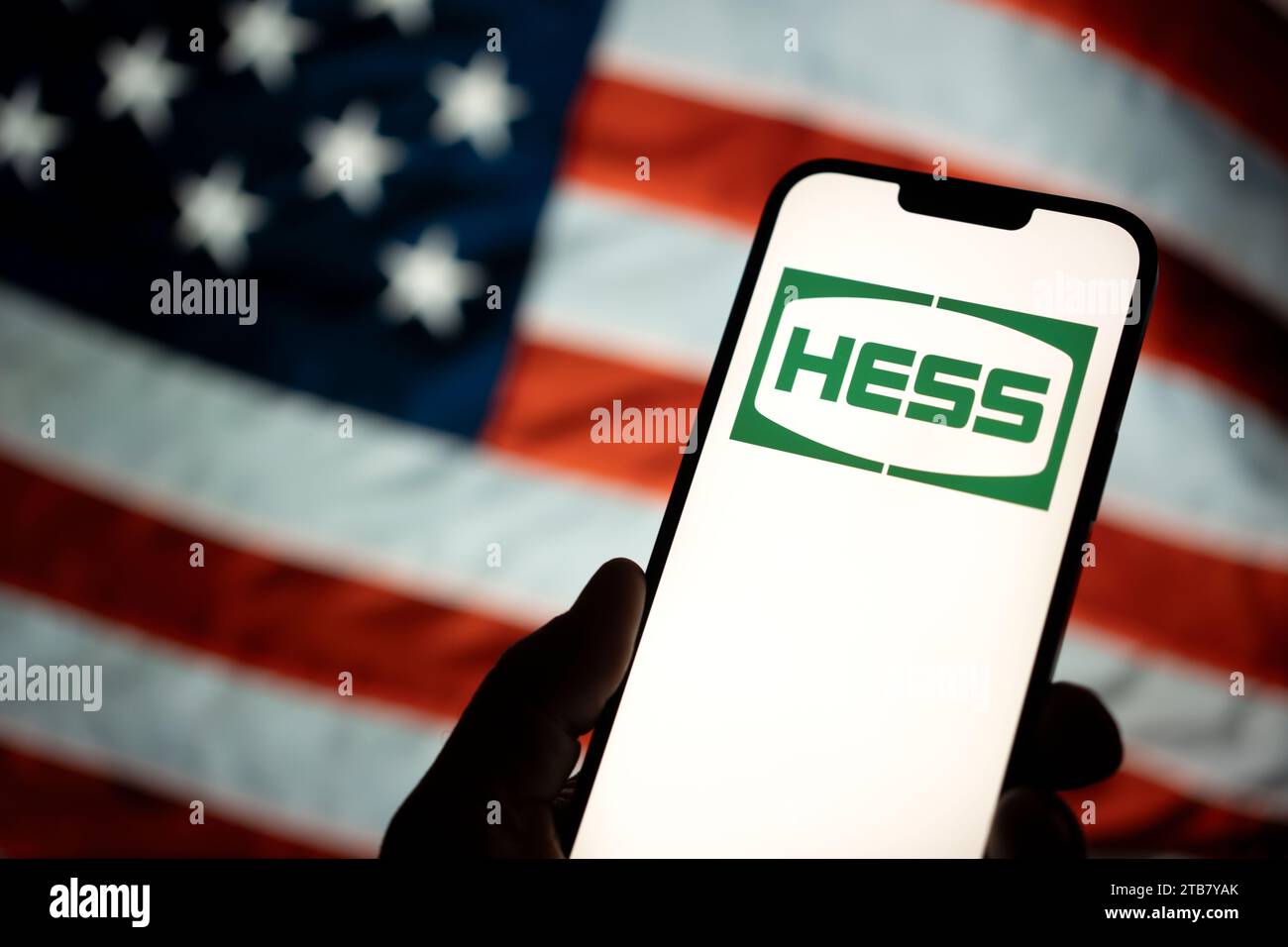 The Hess logo is seen with an American flag in the background in this ...