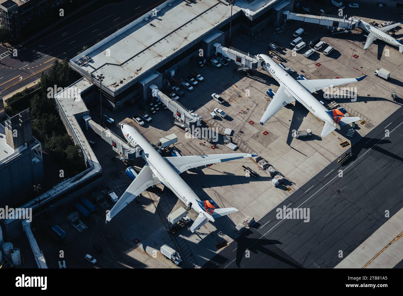 An aerial view of a bustling airport with several Delta Airlines jets ...