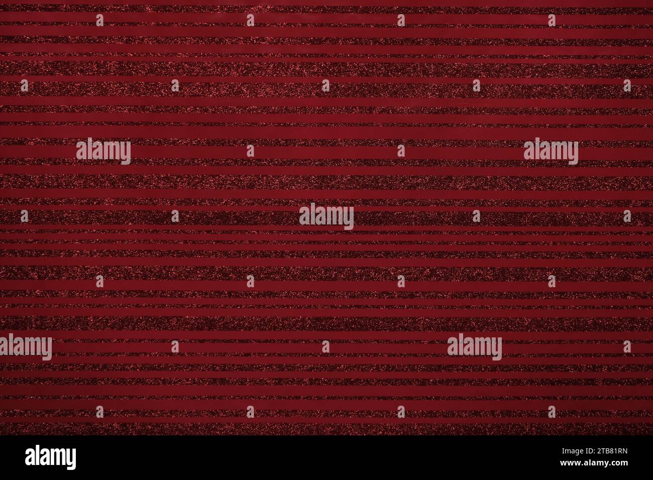 A vivid red fabric background with a texture of roughness and scratches ...