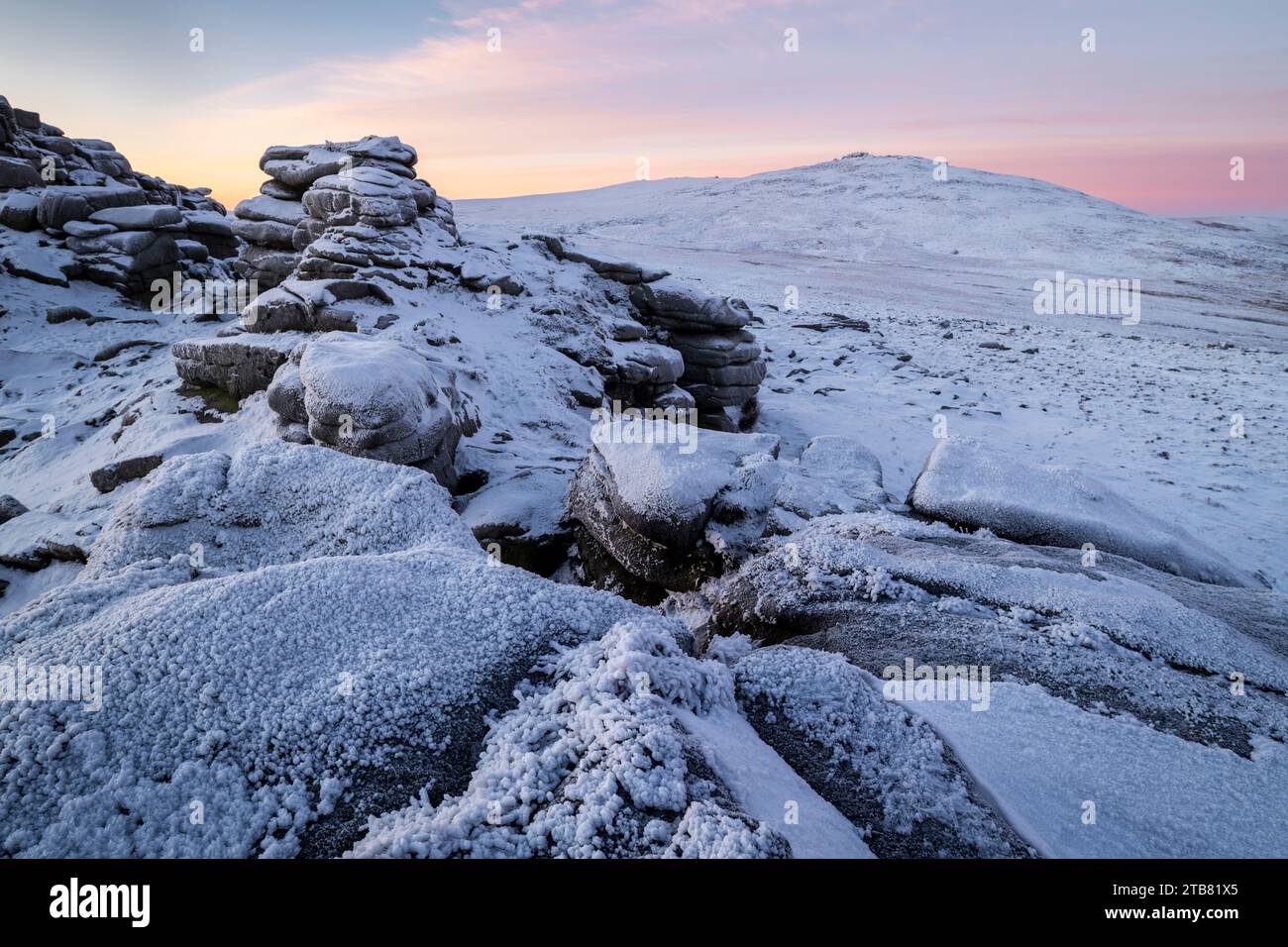 Snow and ice covered moorland at dawn on West Mill Tor in Dartmoor ...
