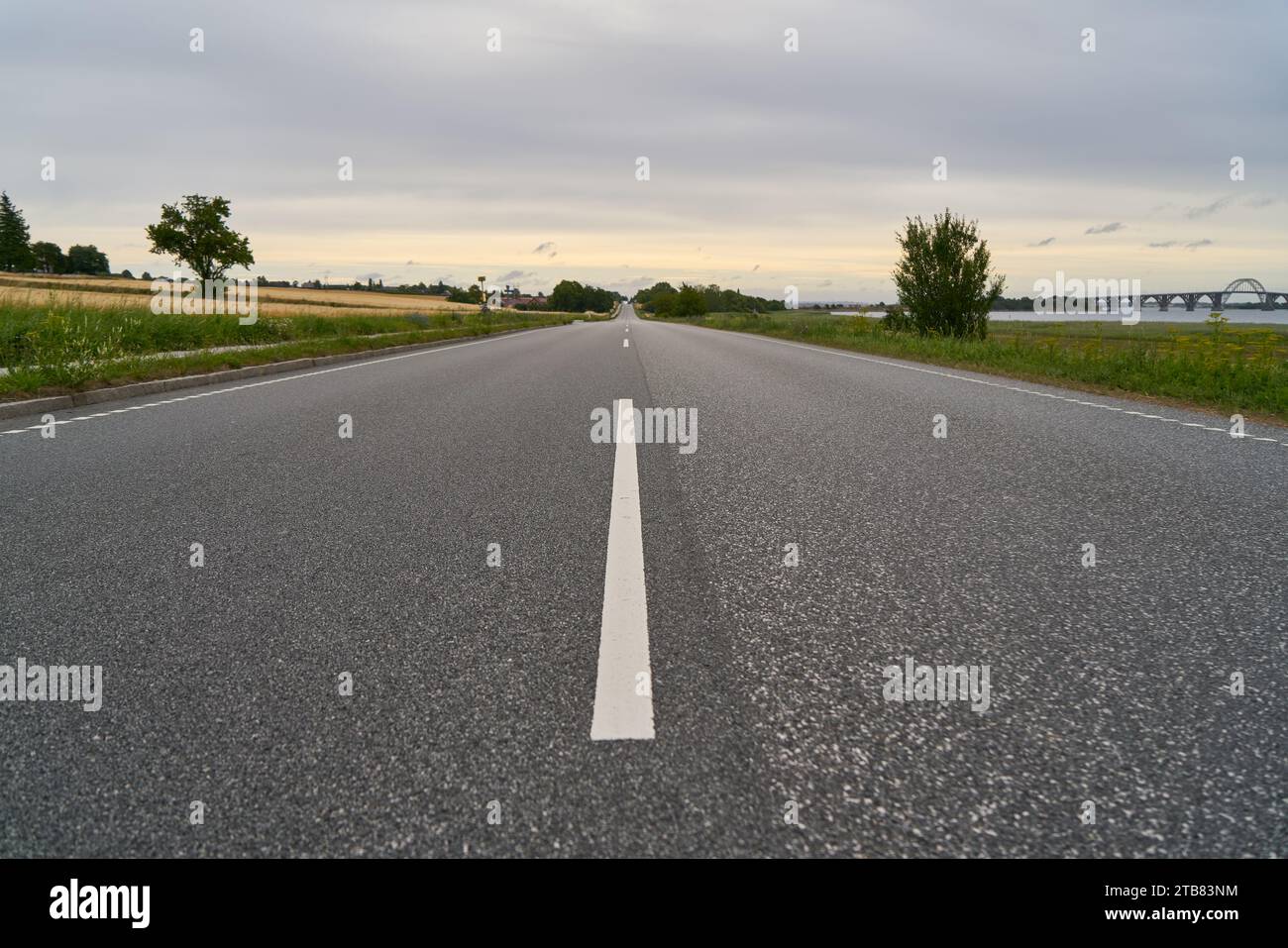 Asphalt street with two lanes and road markings in rural countryside in ...