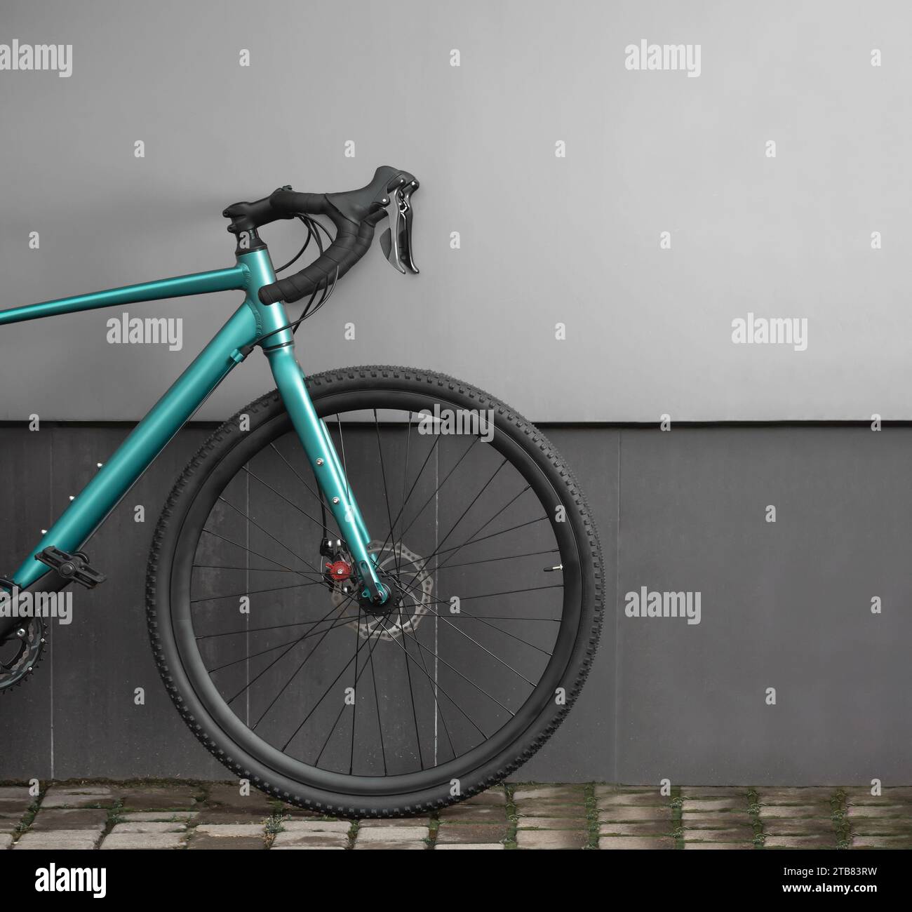 Front part of gravel bike on grey wall background. Modern brand new ...