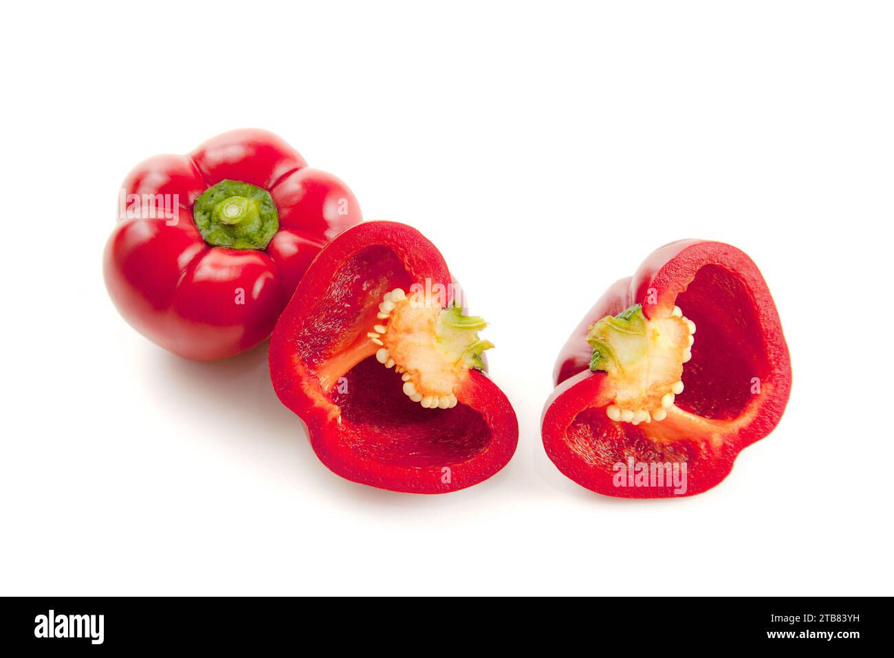 Whole and half of red bell pepper (capsicum) known as sweet bell pepper ...