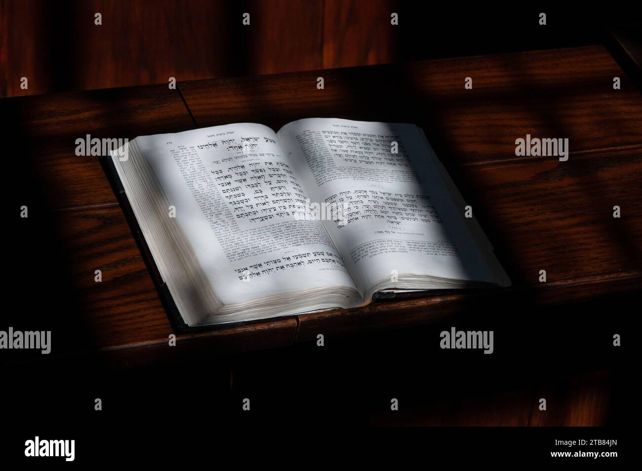 An open Jewish prayer book or siddur lies on a prayer stand in a ...