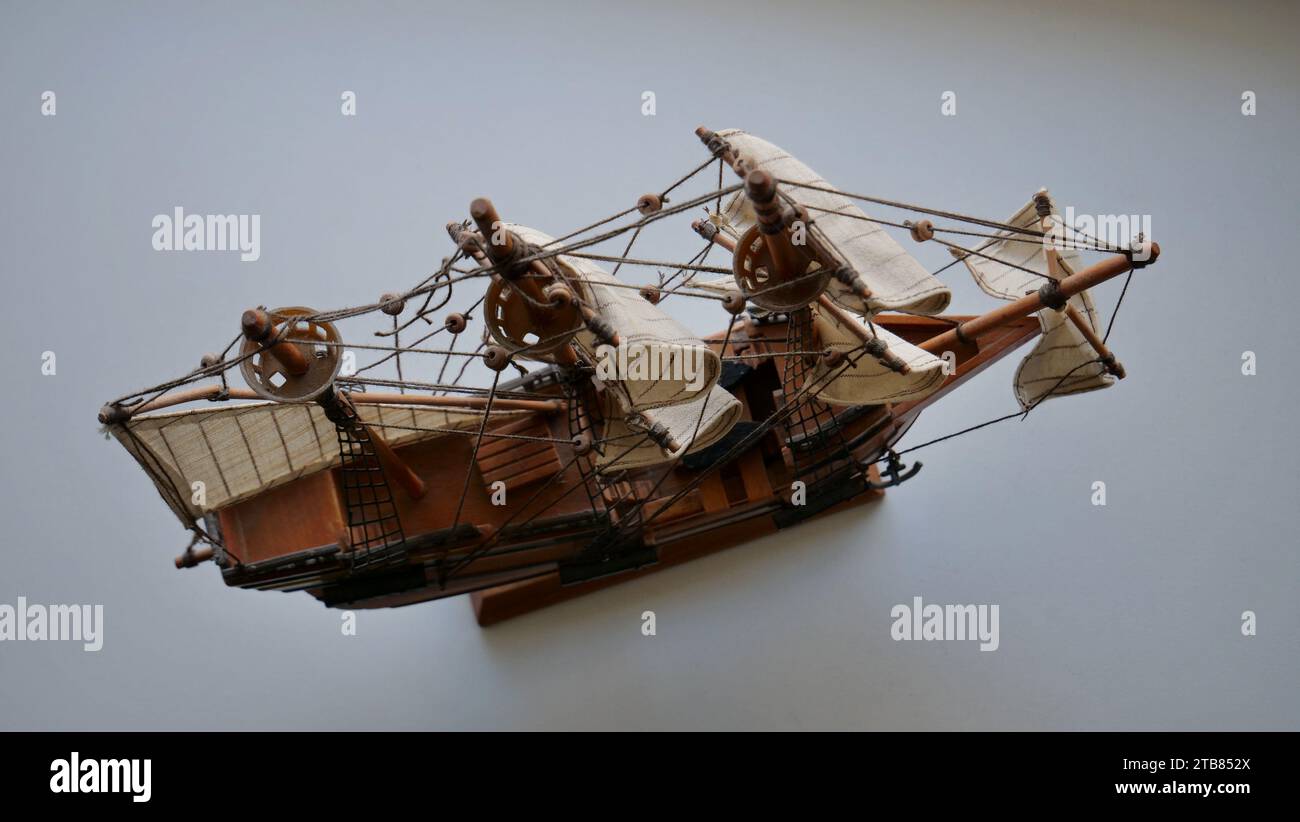 Wooden sailboat scale model with fabric sails and thread ropes top view ...